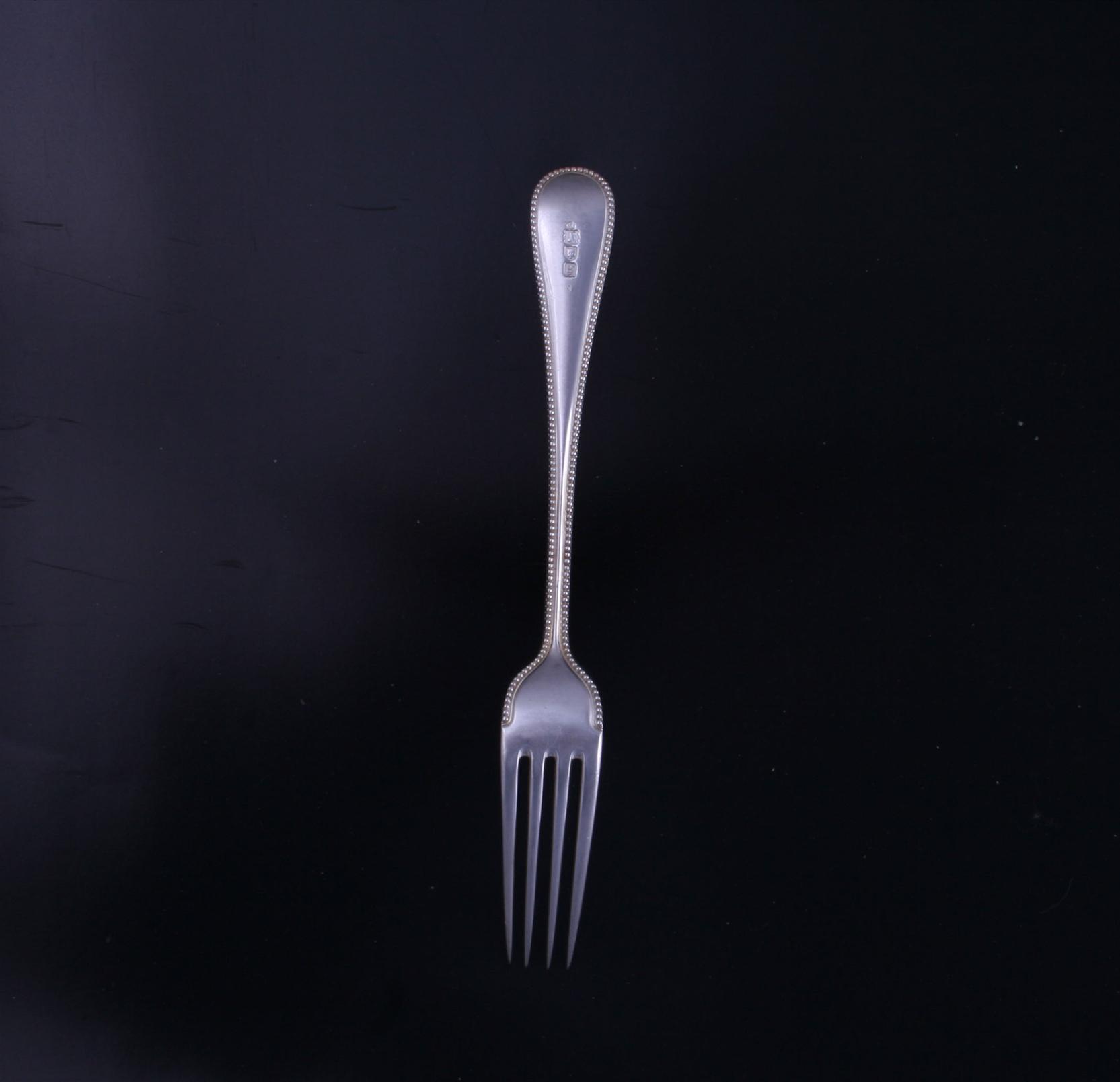 An Edwardian Old English bead edge pattern sterling silver table fork ...