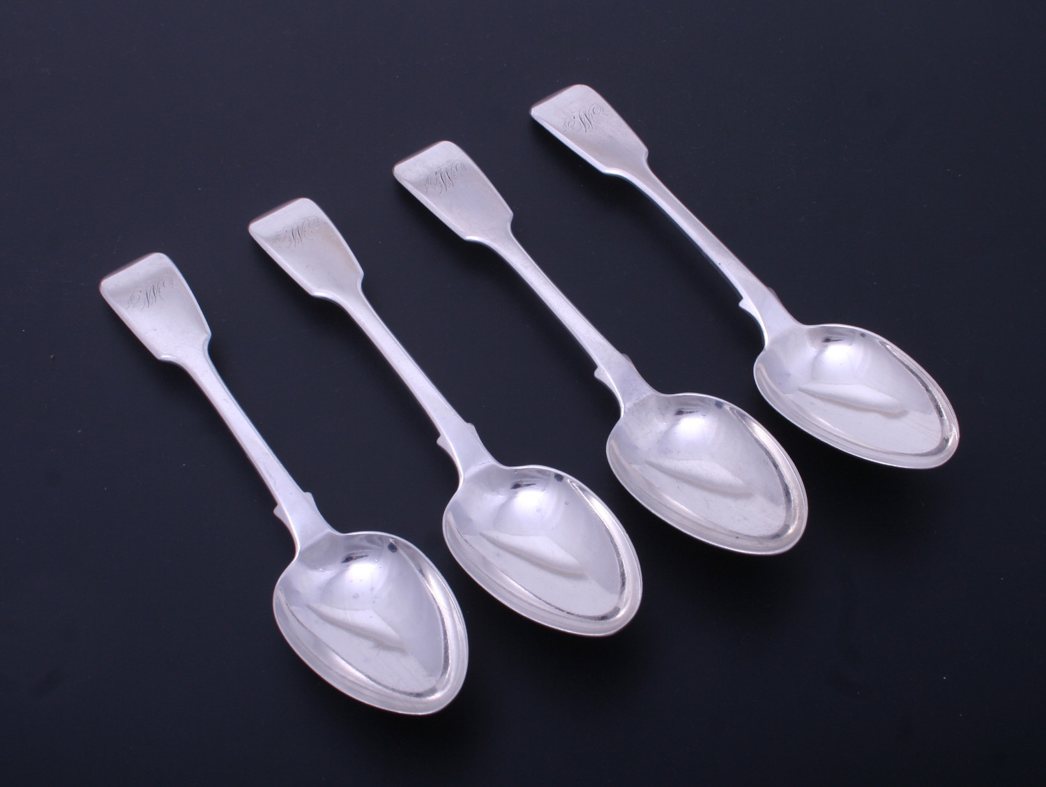 A set of four William IV sterling silver fiddle pattern dessert spoons ...