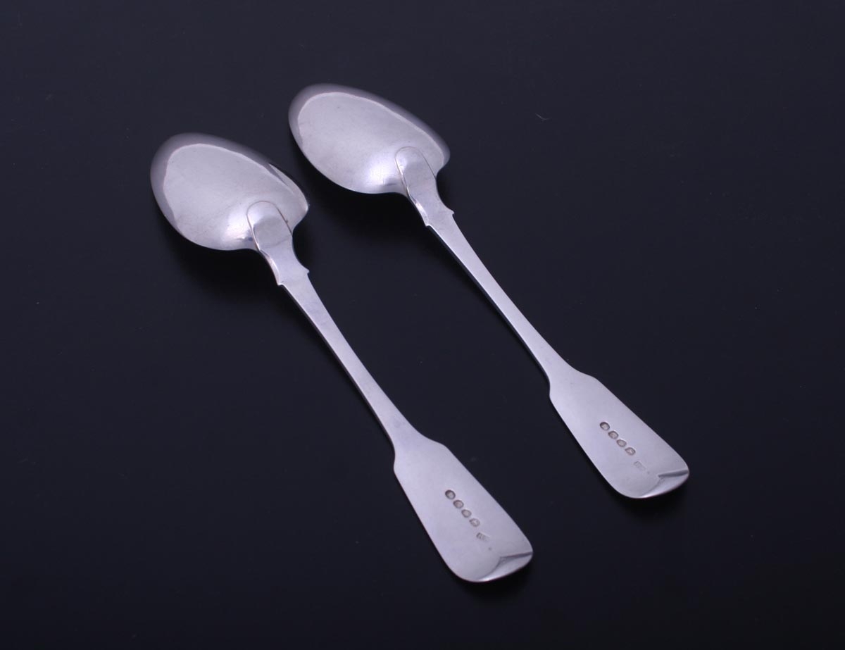 A pair of Regency sterling silver fiddle pattern table spoons ...