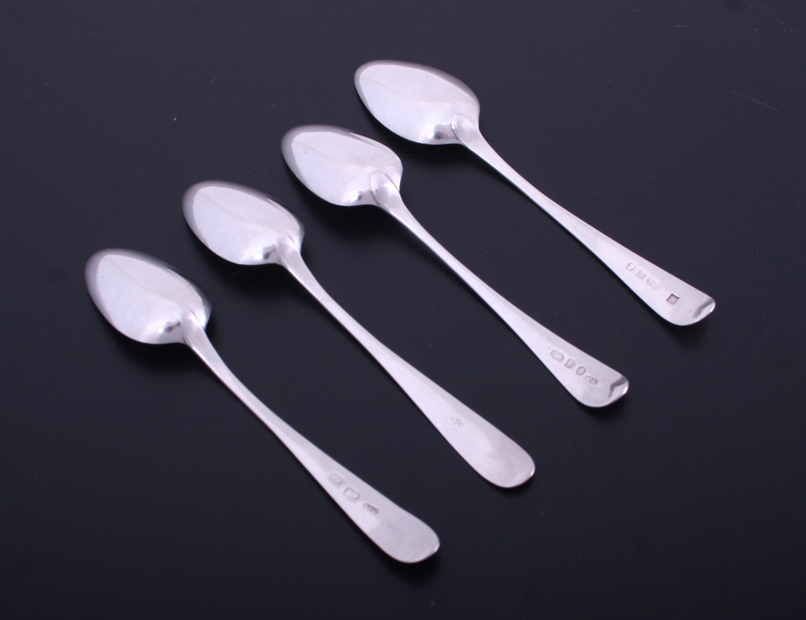 A matched set of four George III Old English pattern sterling silver ...