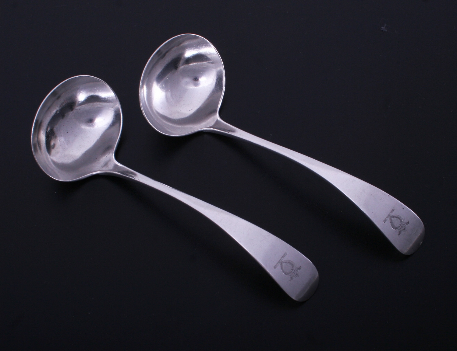 A pair of Victorian Old English pattern sterling silver sauce ladles ...