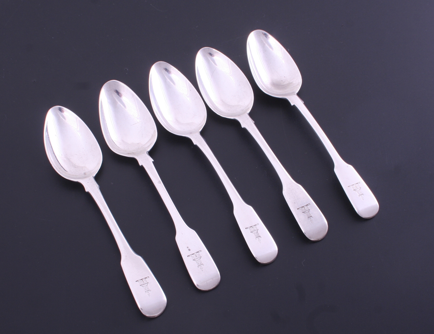 A matched set of five George III/Victorian fiddle pattern silver tea ...